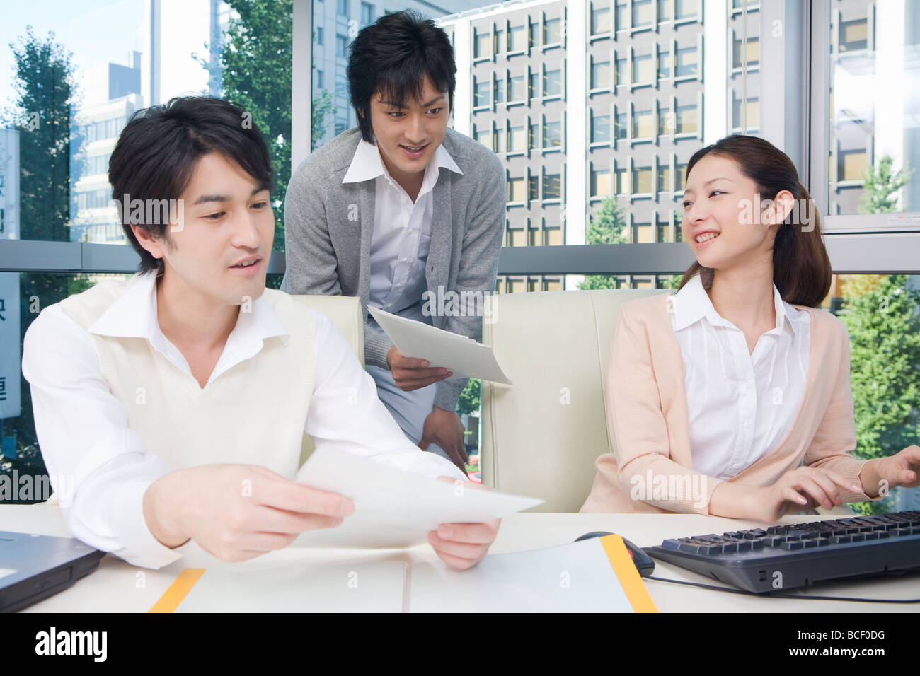 Three people working in office Stock Photo - Alamy