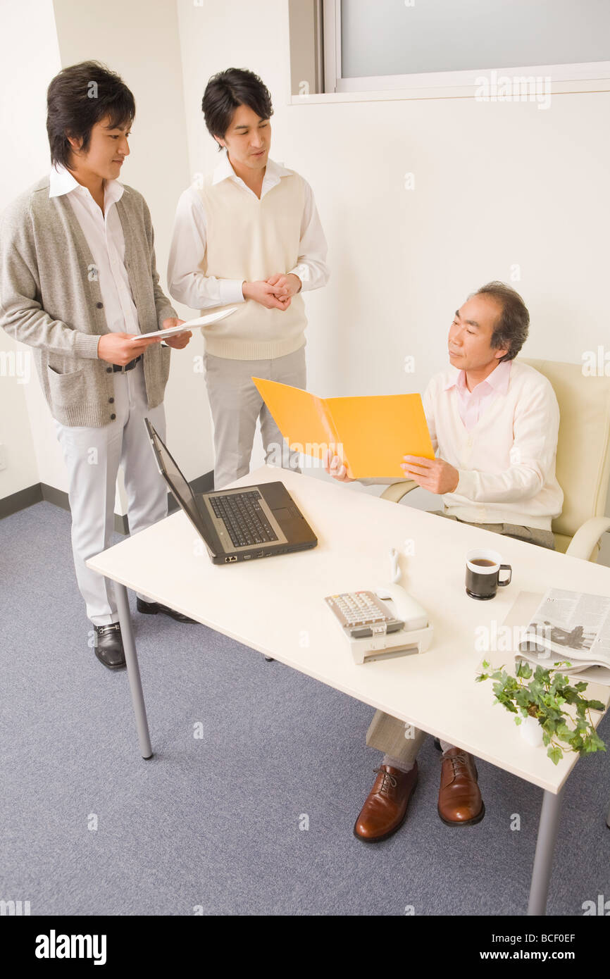 Three people working in office Stock Photo - Alamy