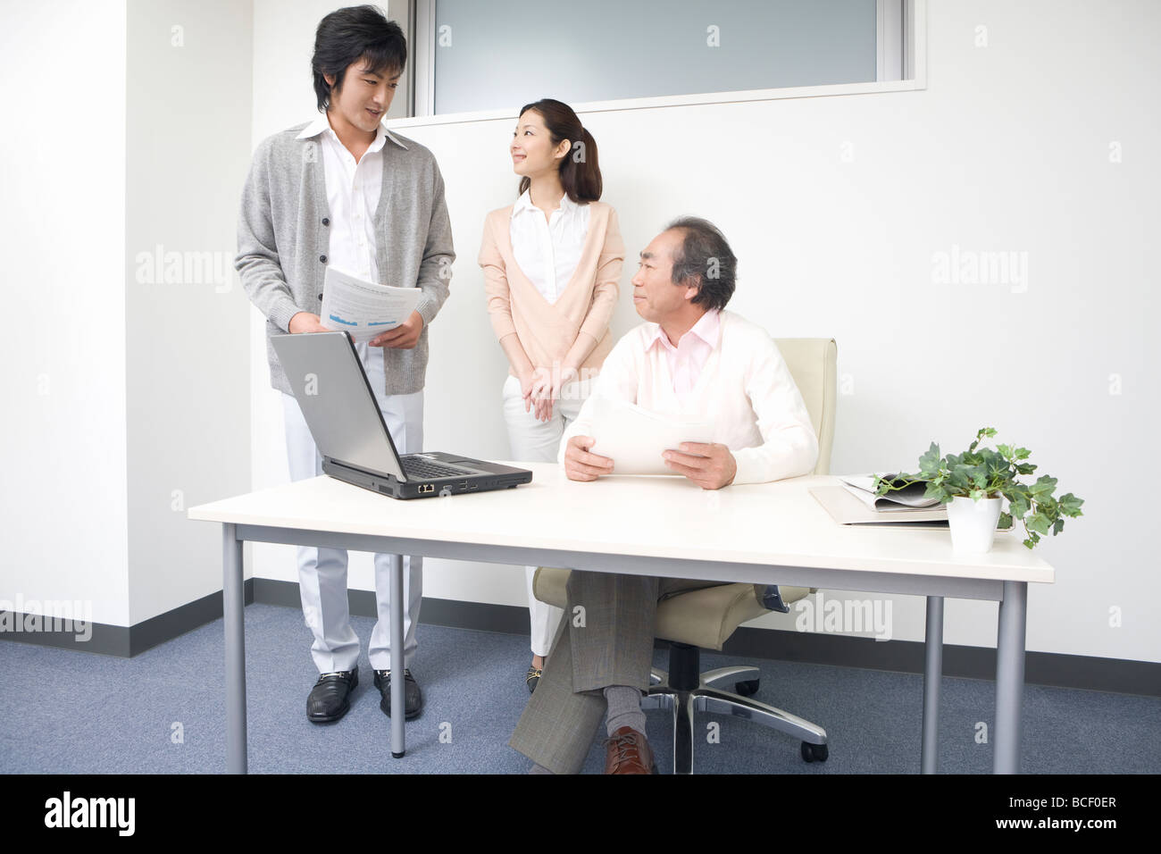 Three people working in office Stock Photo - Alamy