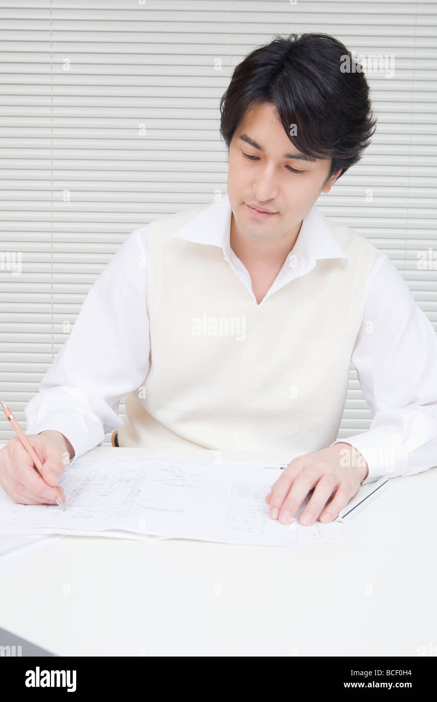 Businessman writing in office Stock Photo - Alamy