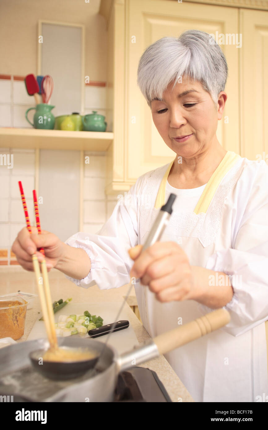 Senior woman cooking Stock Photo - Alamy