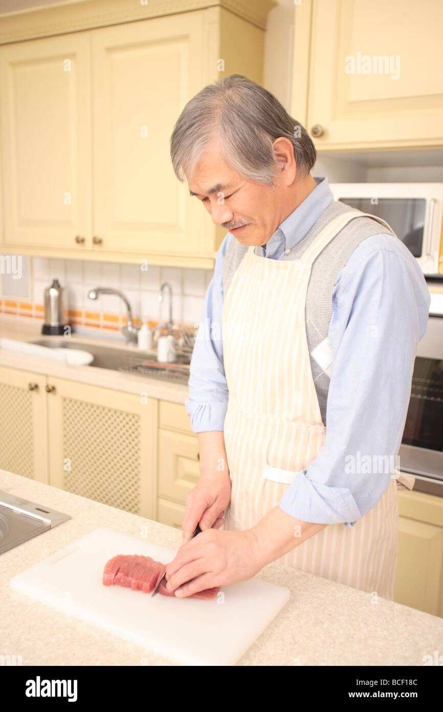 Senior man cooking Stock Photo - Alamy