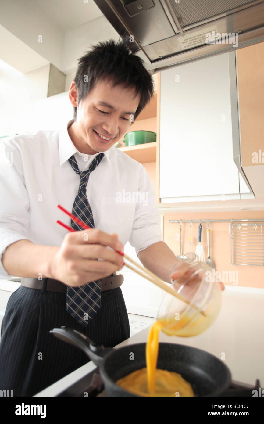 Businessman cooking in kitchen Stock Photo - Alamy