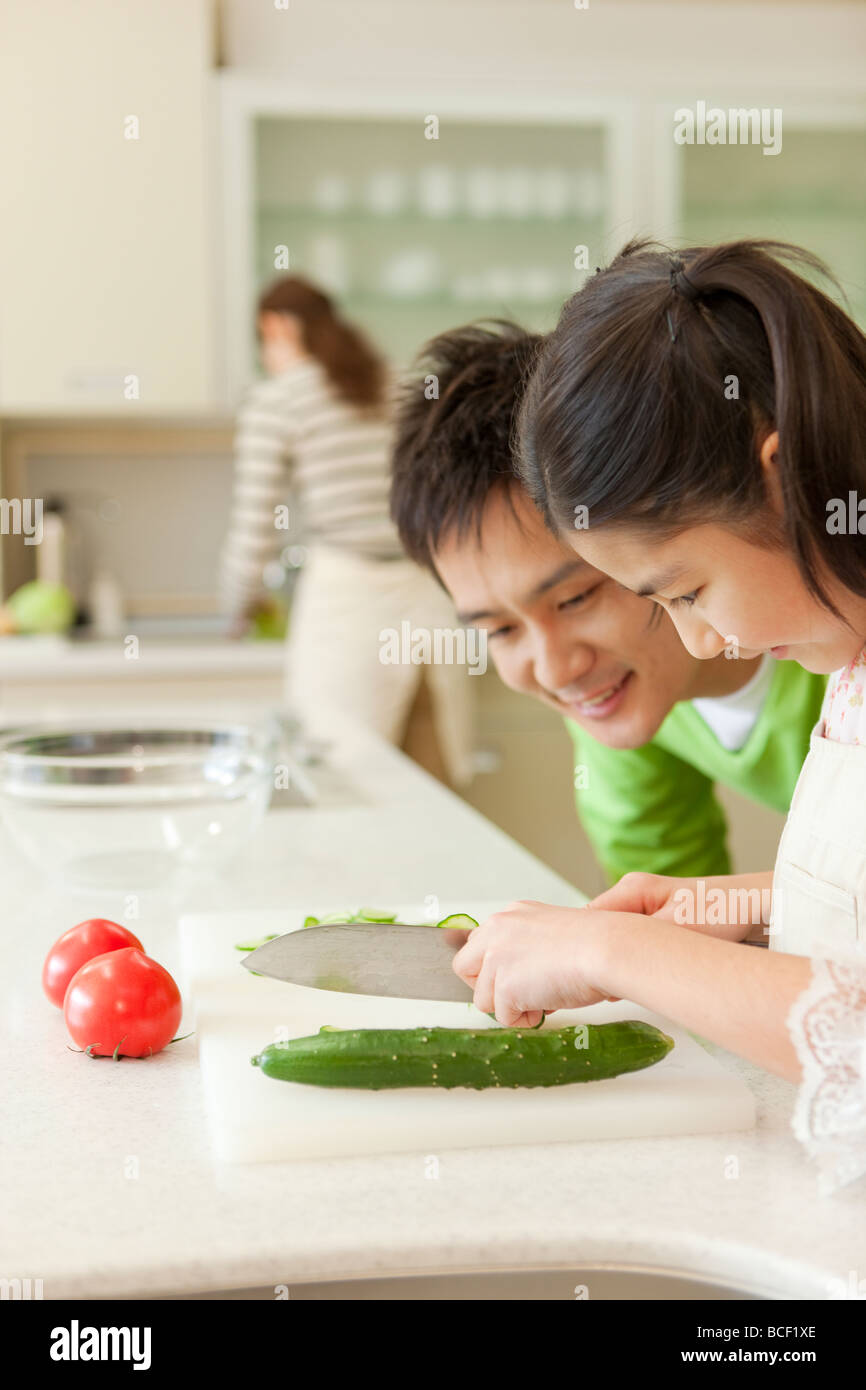 Parents and daughter cooking Stock Photo - Alamy