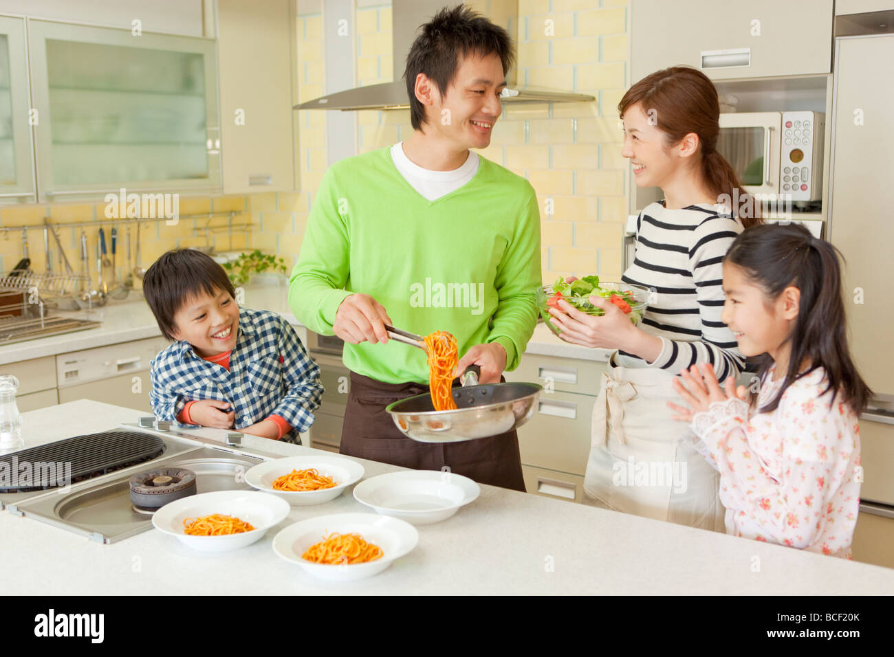 Parents and children cooking Stock Photo - Alamy