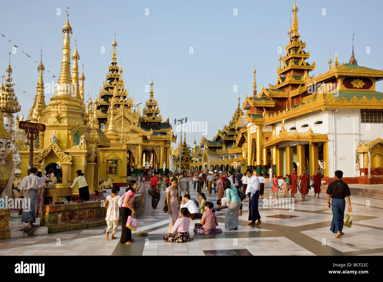 Myanmar, Burma, Yangon. Buddhists pray at the small stupas, temples ...