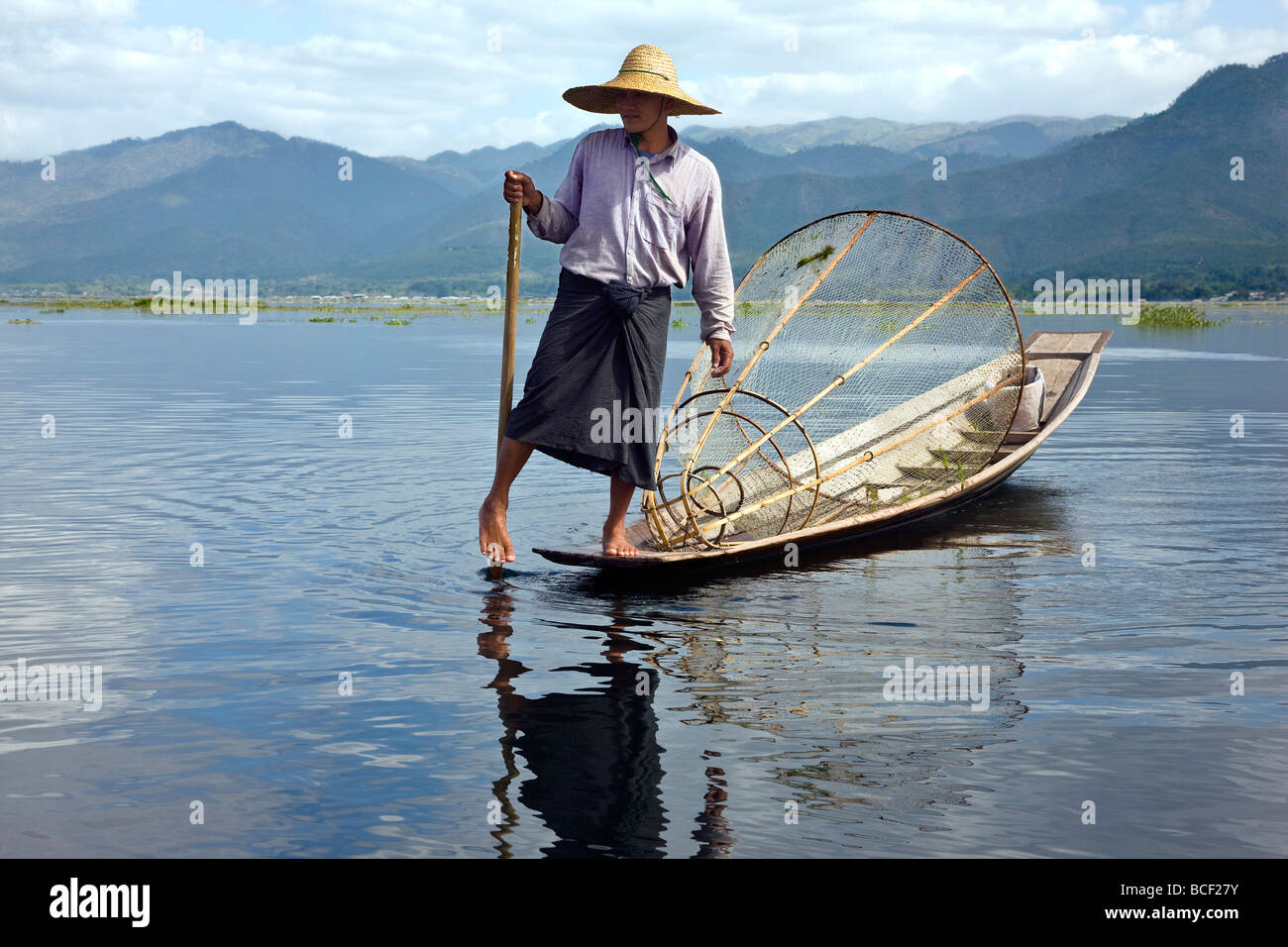 Myanmar. Burma. Lake Inle. An Intha fisherman uses a traditional cone ...