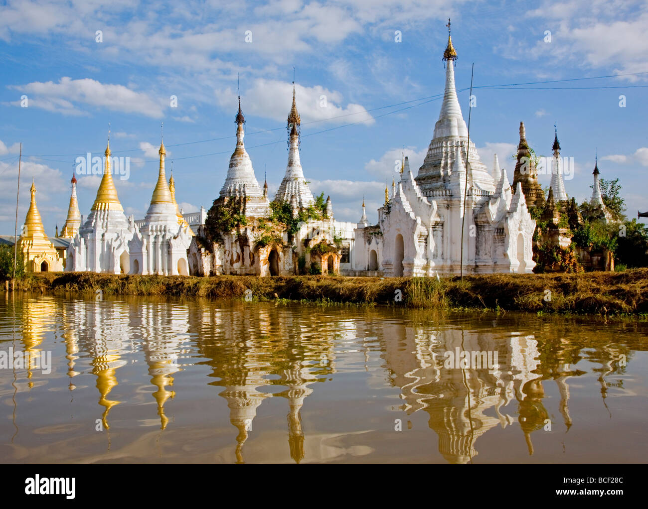 Myanmar, Burma, Lake Inle. Buddhist shrines reflected in the waters of ...