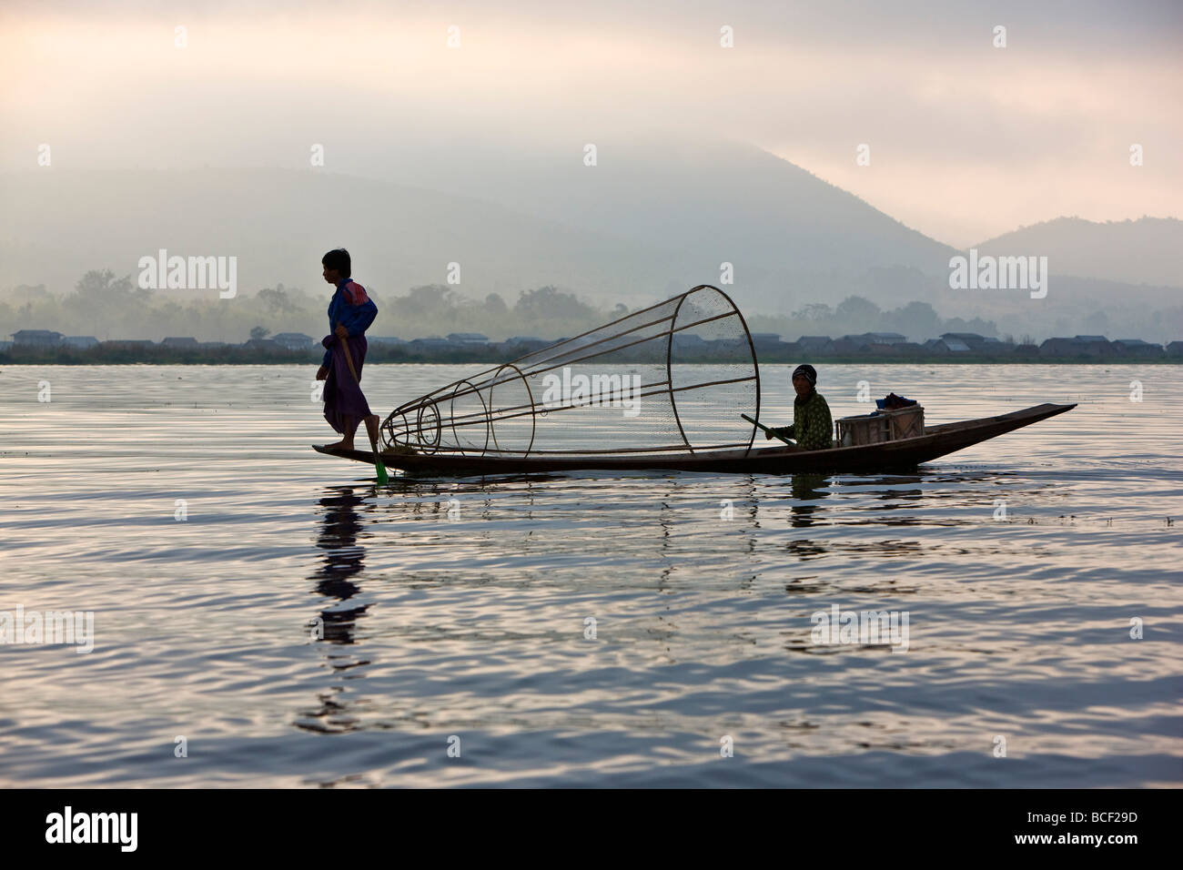 Myanmar, Burma, Lake Inle. An Intha fisherman with traditional fish ...