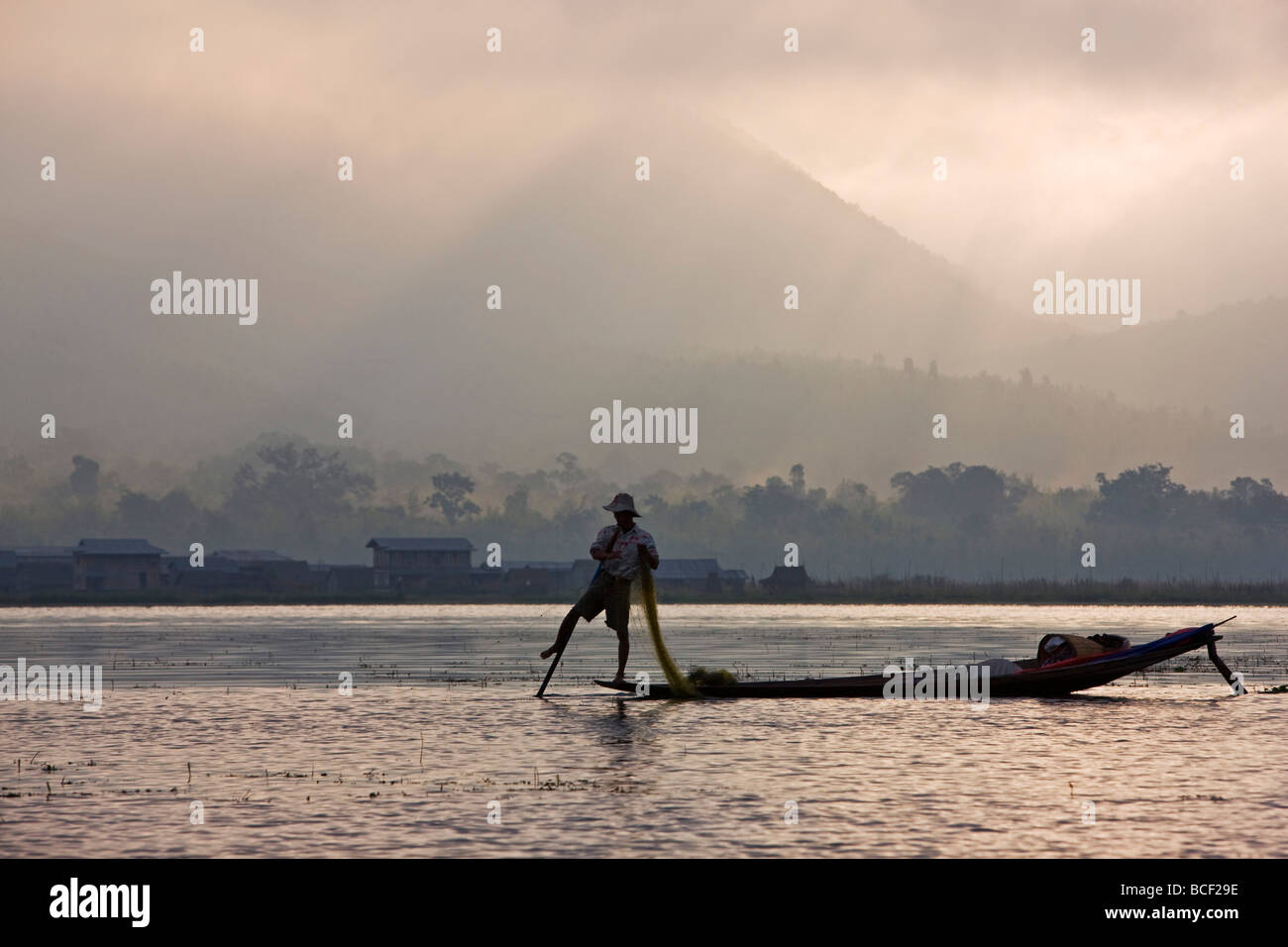 Myanmar, Burma, Lake Inle. An Intha fisherman with traditional fish ...