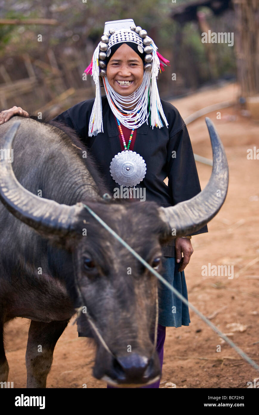 Myanmar, Burma, Namu-op. A happy Akha woman stands beside her favourite ...