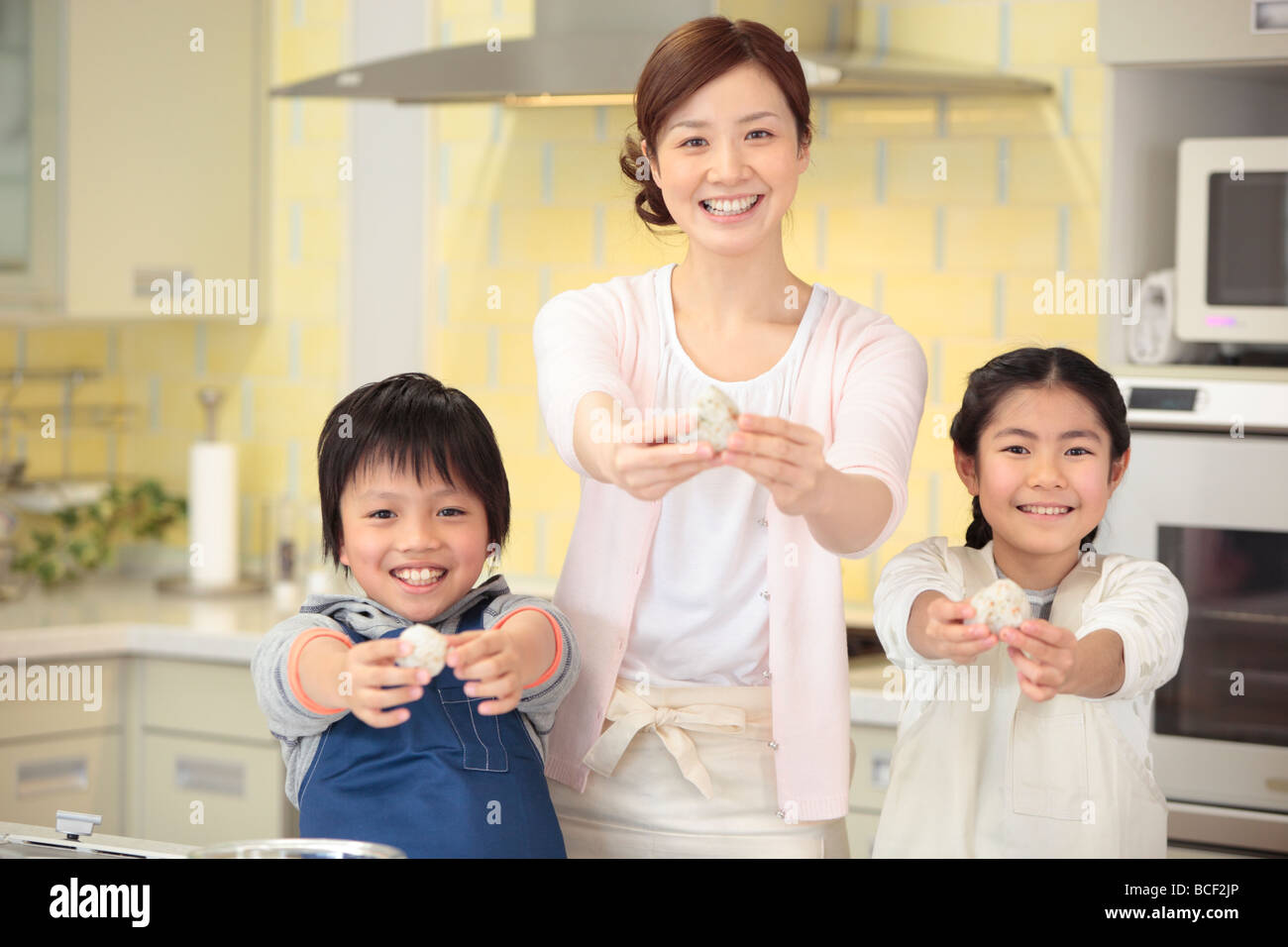 Mother and children holding rice ball Stock Photo - Alamy