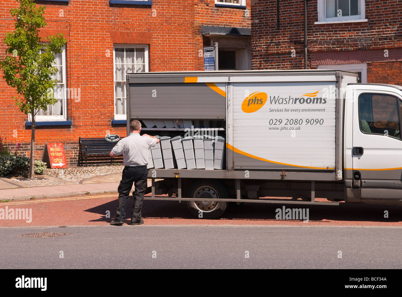A man at his Phs washrooms van providing washroom services office plant ...