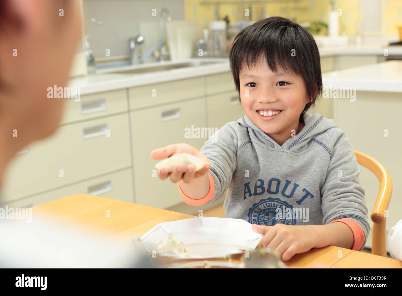 Boy cooking pot-sticker Stock Photo - Alamy