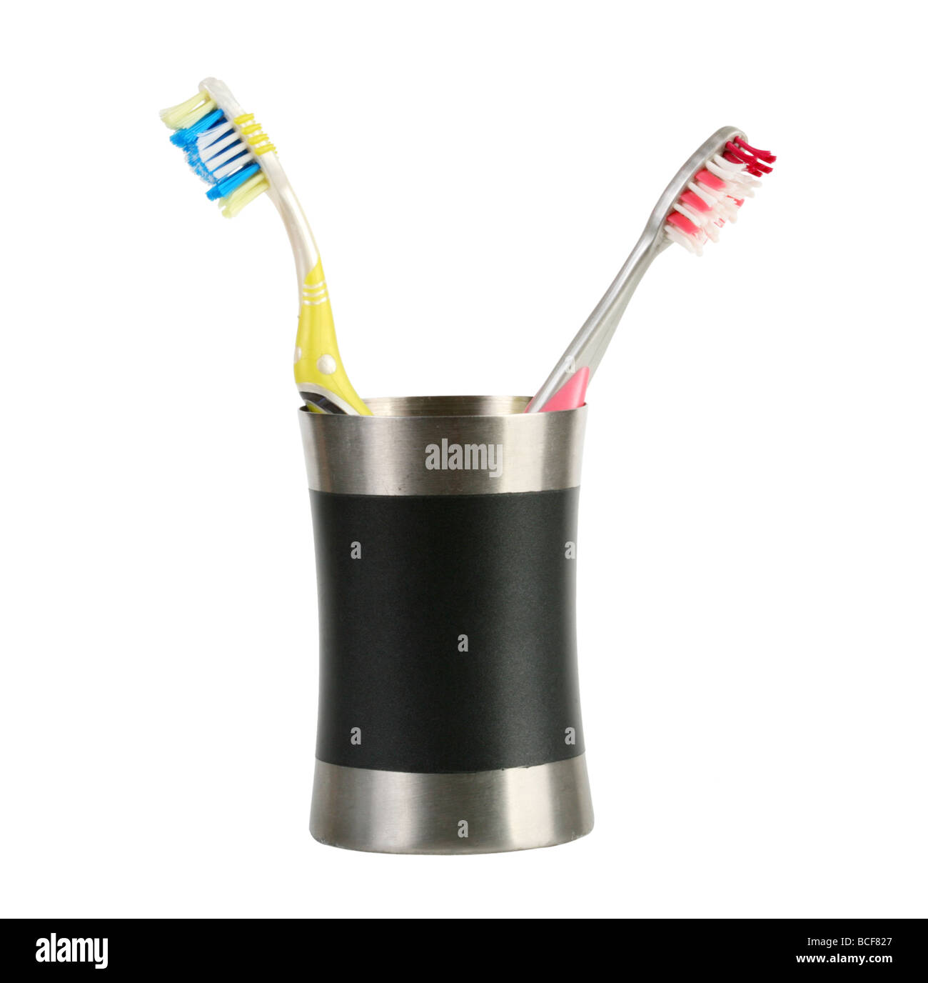 Toothbrushes in a cup on a white background Stock Photo - Alamy