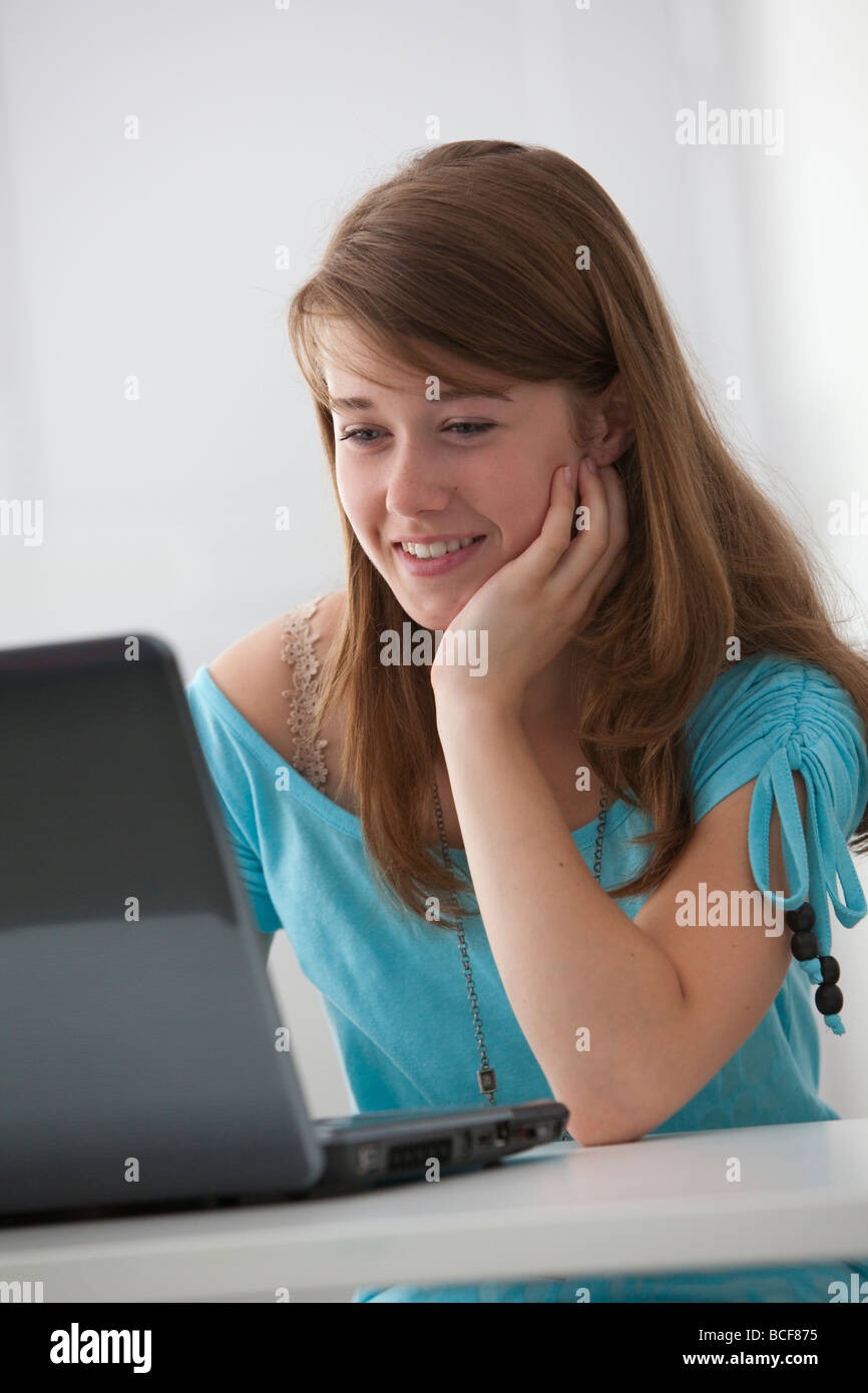 Teenage girl behind a laptop Stock Photo - Alamy