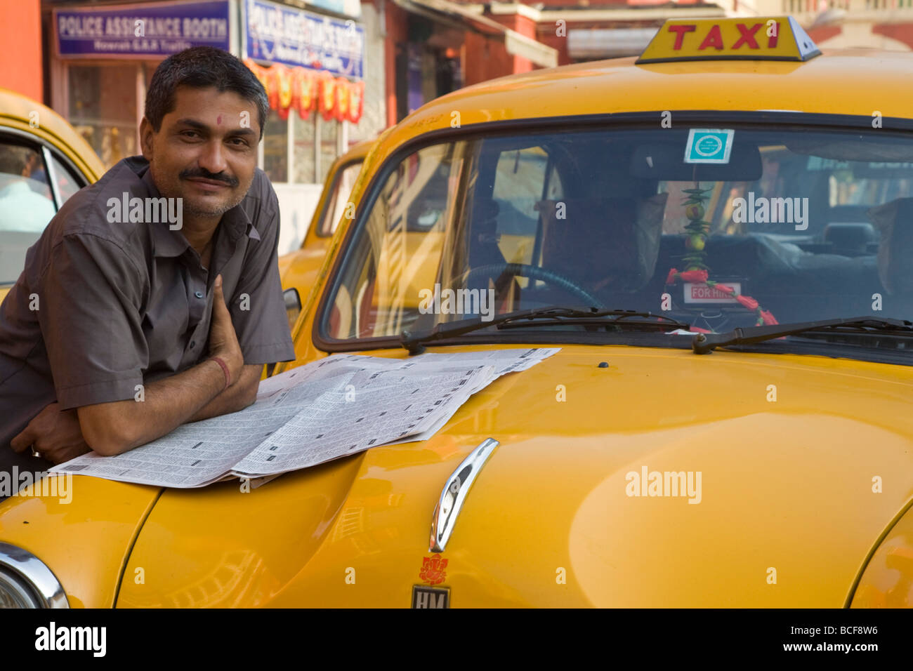 India, West Bengal, Kolkata, Calcutta, Yellow ambassador taxi driver ...