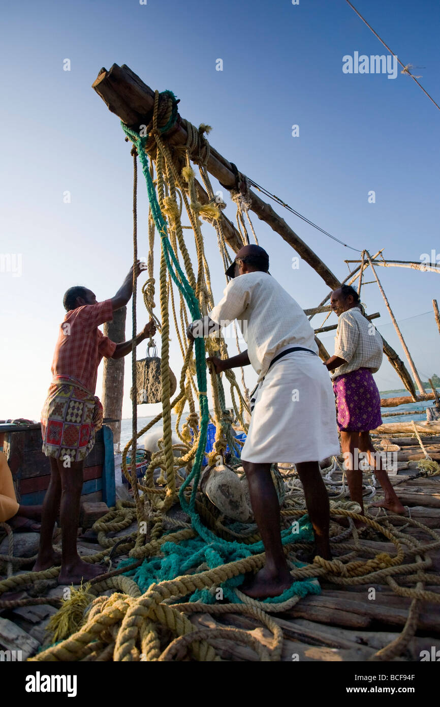 Fishermen and traditional fishing nets, Fort Cochin, Kerala, India ...