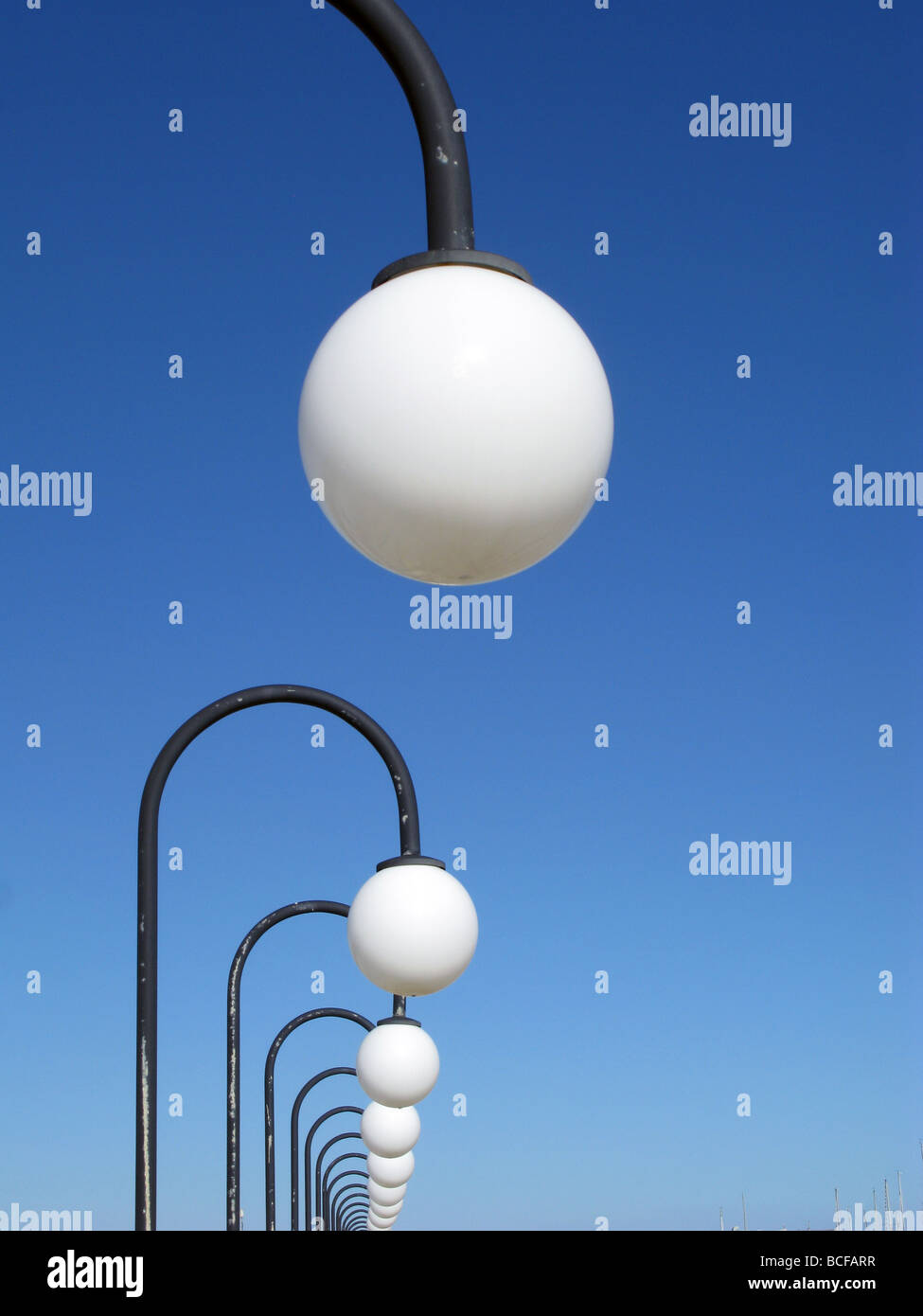 a long row line of street lights and blue sky Stock Photo - Alamy