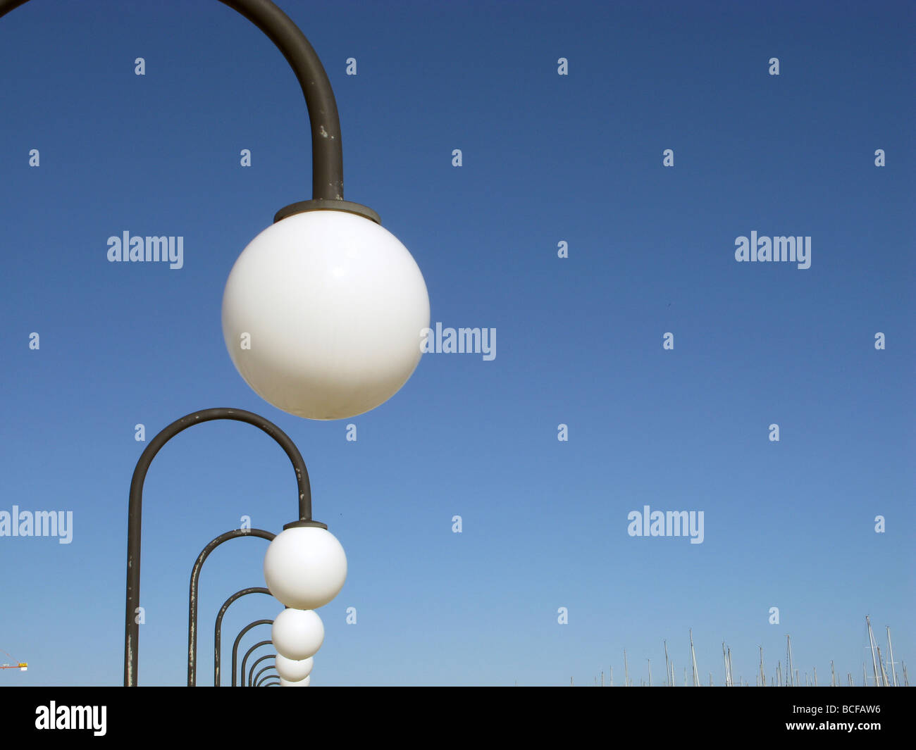 a long row line of street lights and blue sky Stock Photo - Alamy