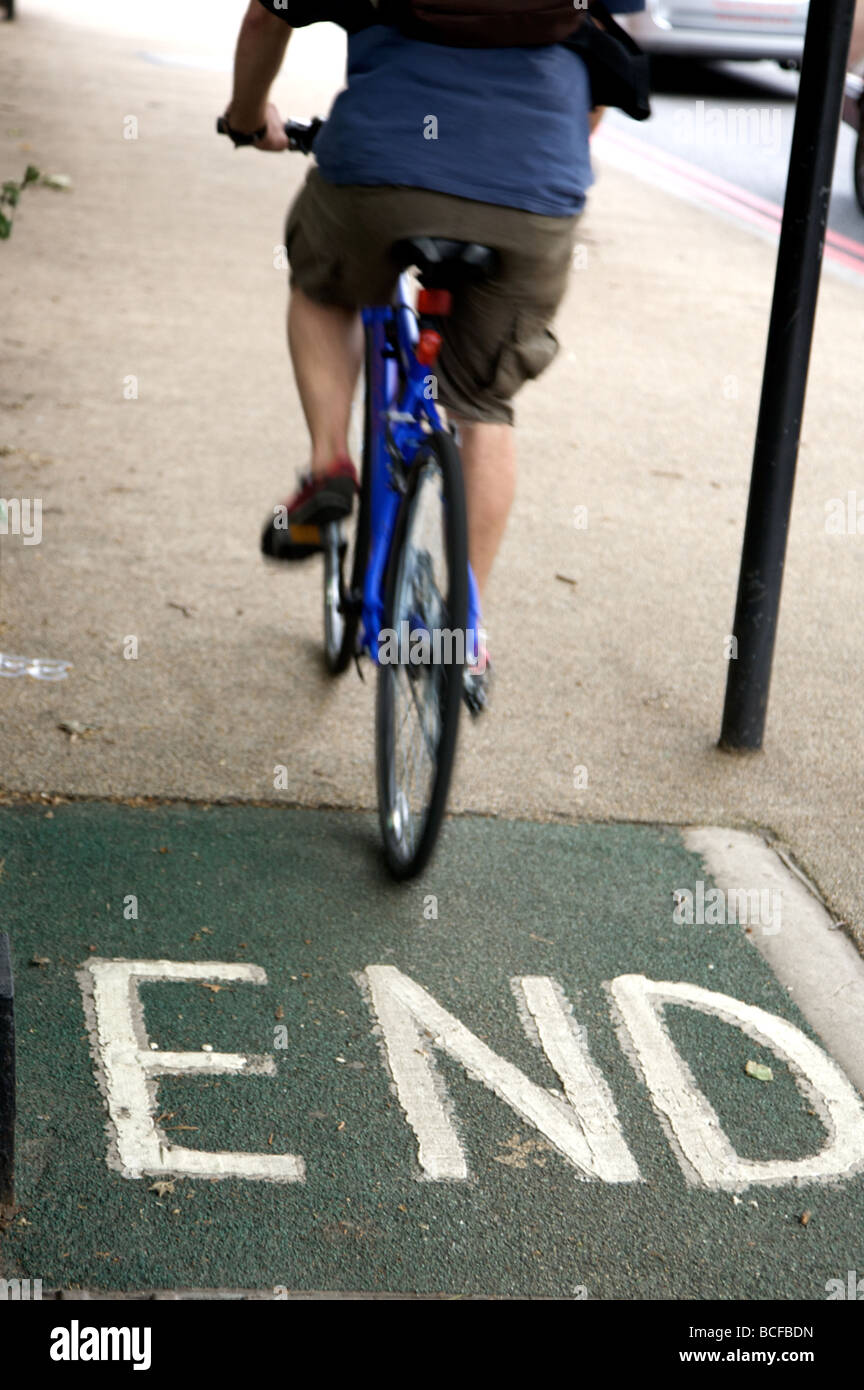 A cyclist leaves a cycle lane on the Chelsea embankment, London, UK ...