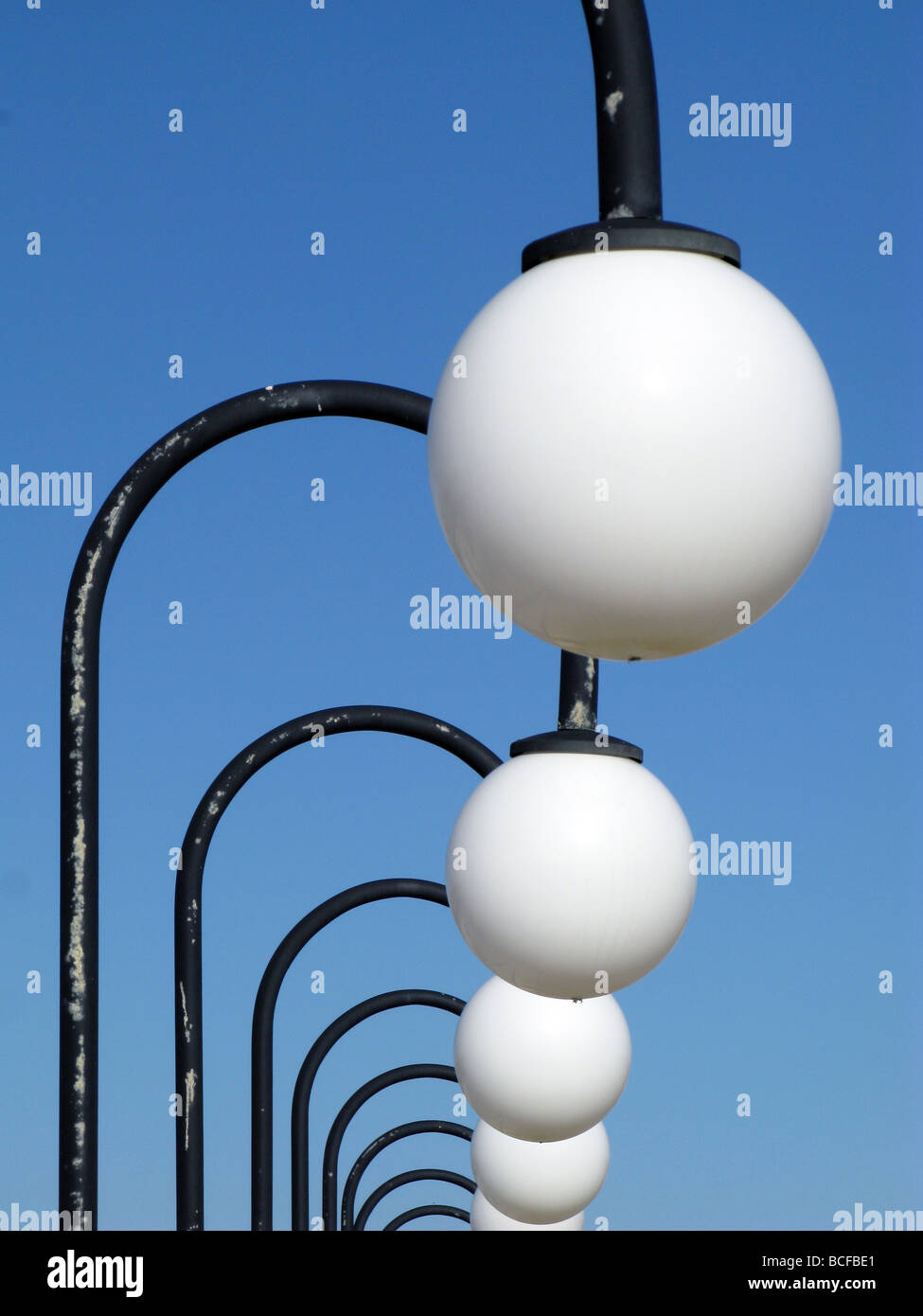 a long row line of street lights and blue sky Stock Photo - Alamy