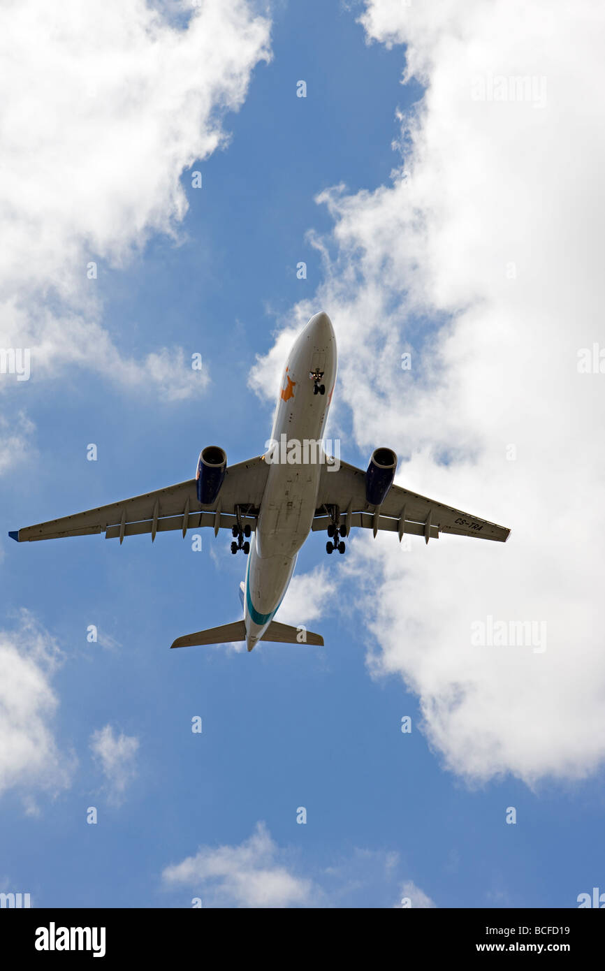 A plane landing seen from below Stock Photo - Alamy
