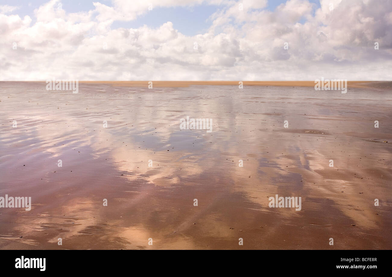 a totally empty beach featuring clouds refleted in wet sand Stock Photo ...
