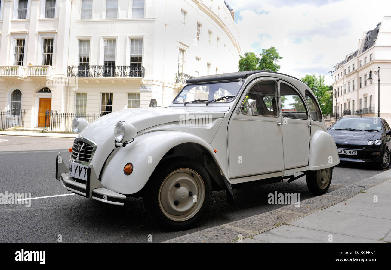 A white Citroen 2CV classic car parked in residents parking spot in ...