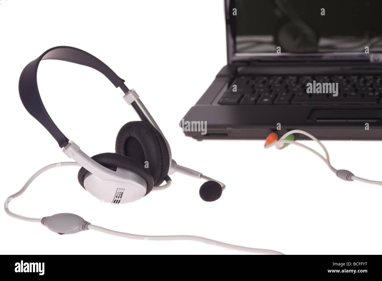 black laptop with headset on white background Stock Photo - Alamy