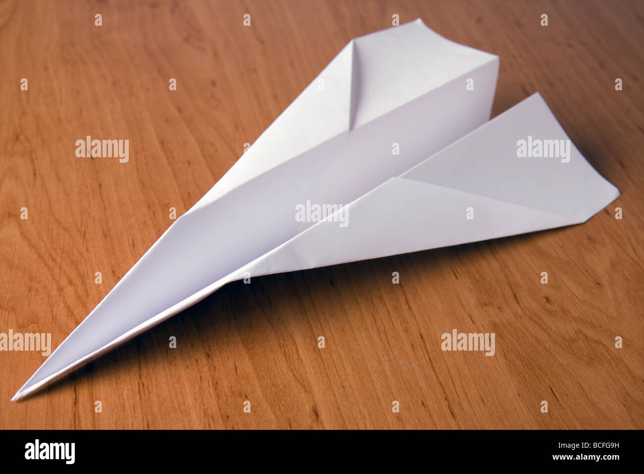 white paper plane on table Stock Photo - Alamy
