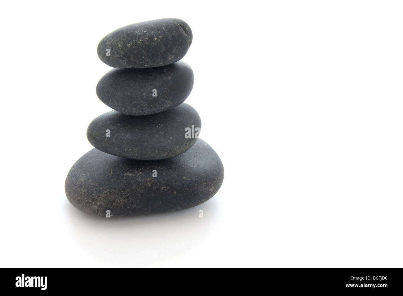 Stack of four basalt pebbles isolated on a white background Stock Photo ...
