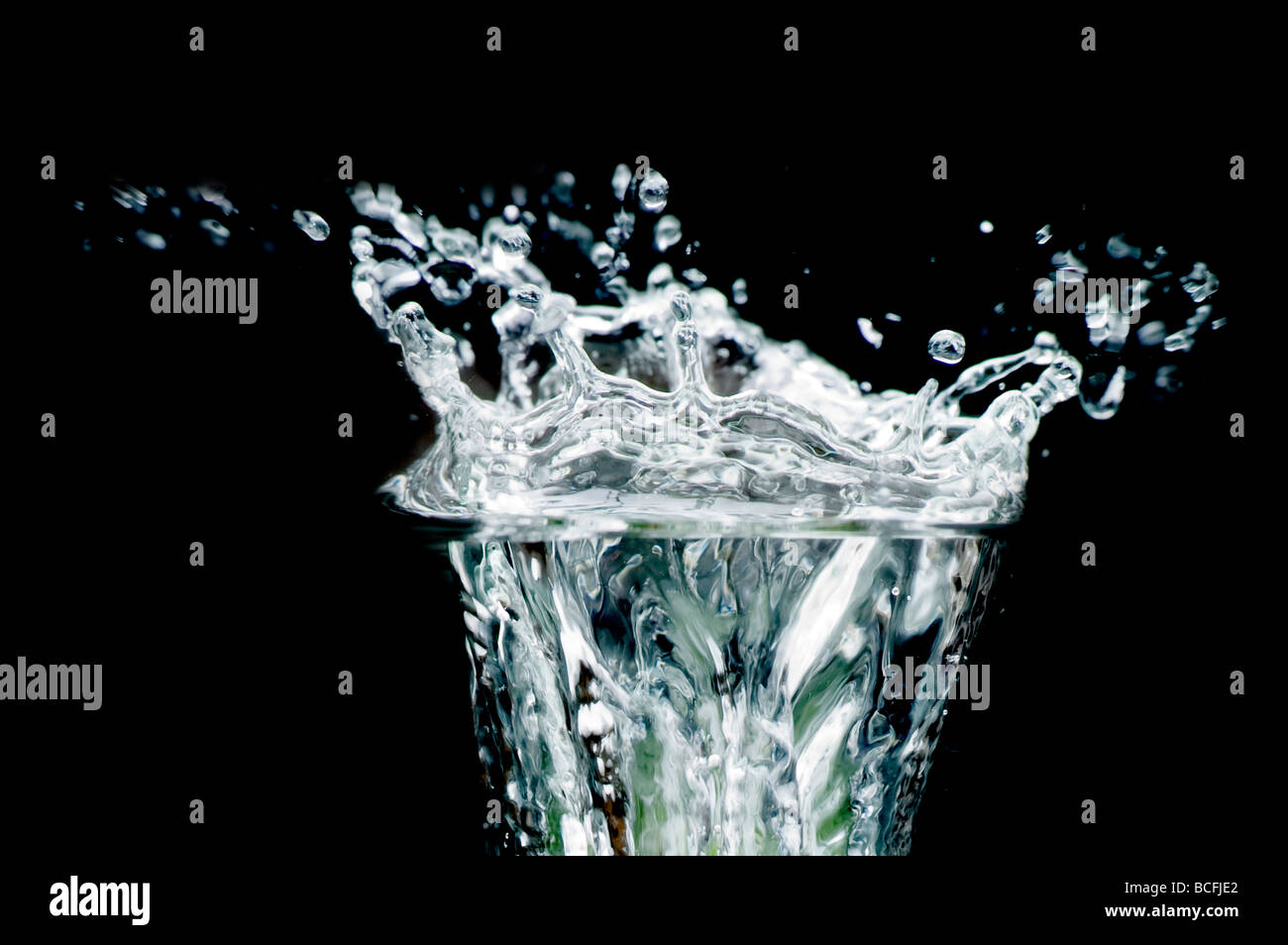 object on black splash water close up Stock Photo - Alamy
