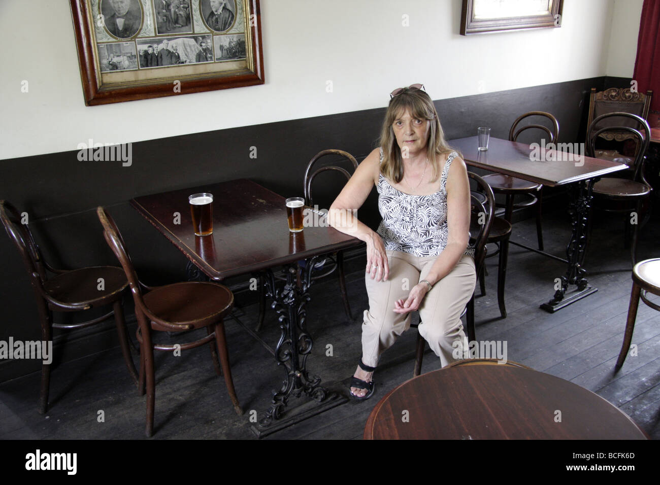 A woman sitting in a very old fashioned pub at the Black Country Museum ...