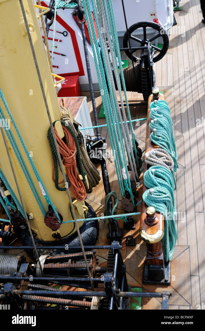 Looking down at ships deck with rigging lines from sails and winches ...