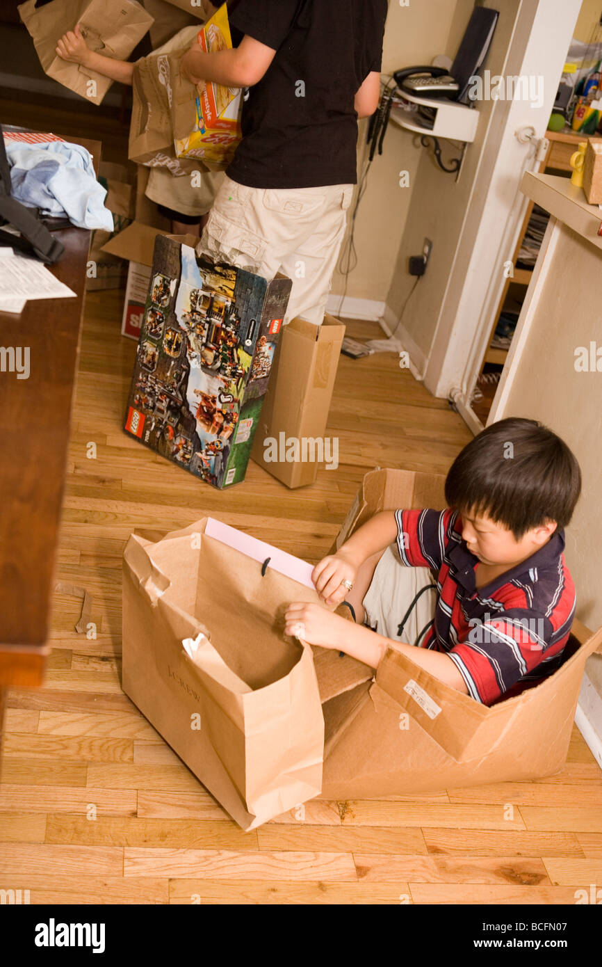 nine year old boy and friends creating forts and costumes out of ...