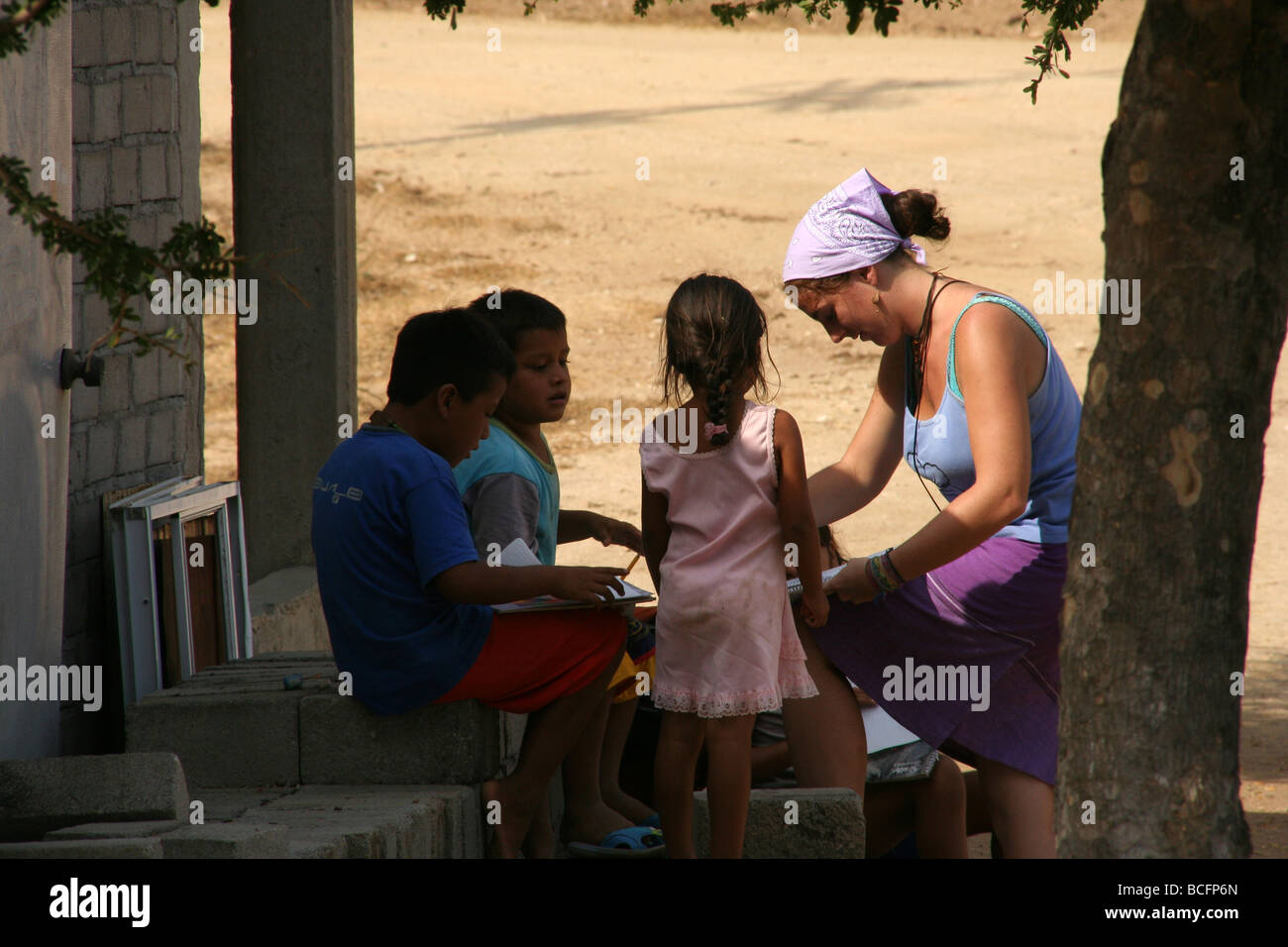 Volunteer teaching indigenous children Stock Photo - Alamy