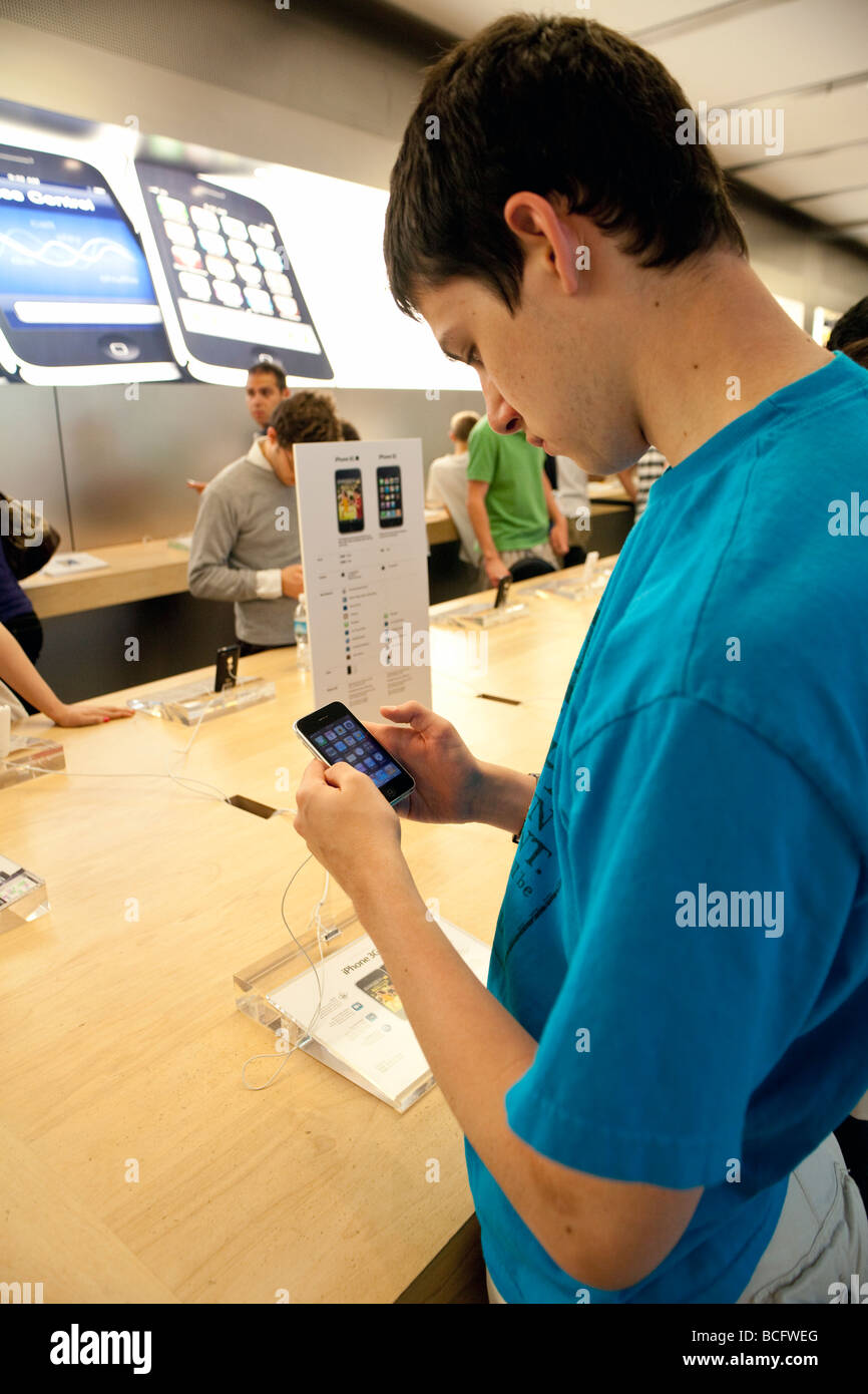 teenager examining iPhone at Fifth Avenue Apple store, New York City ...