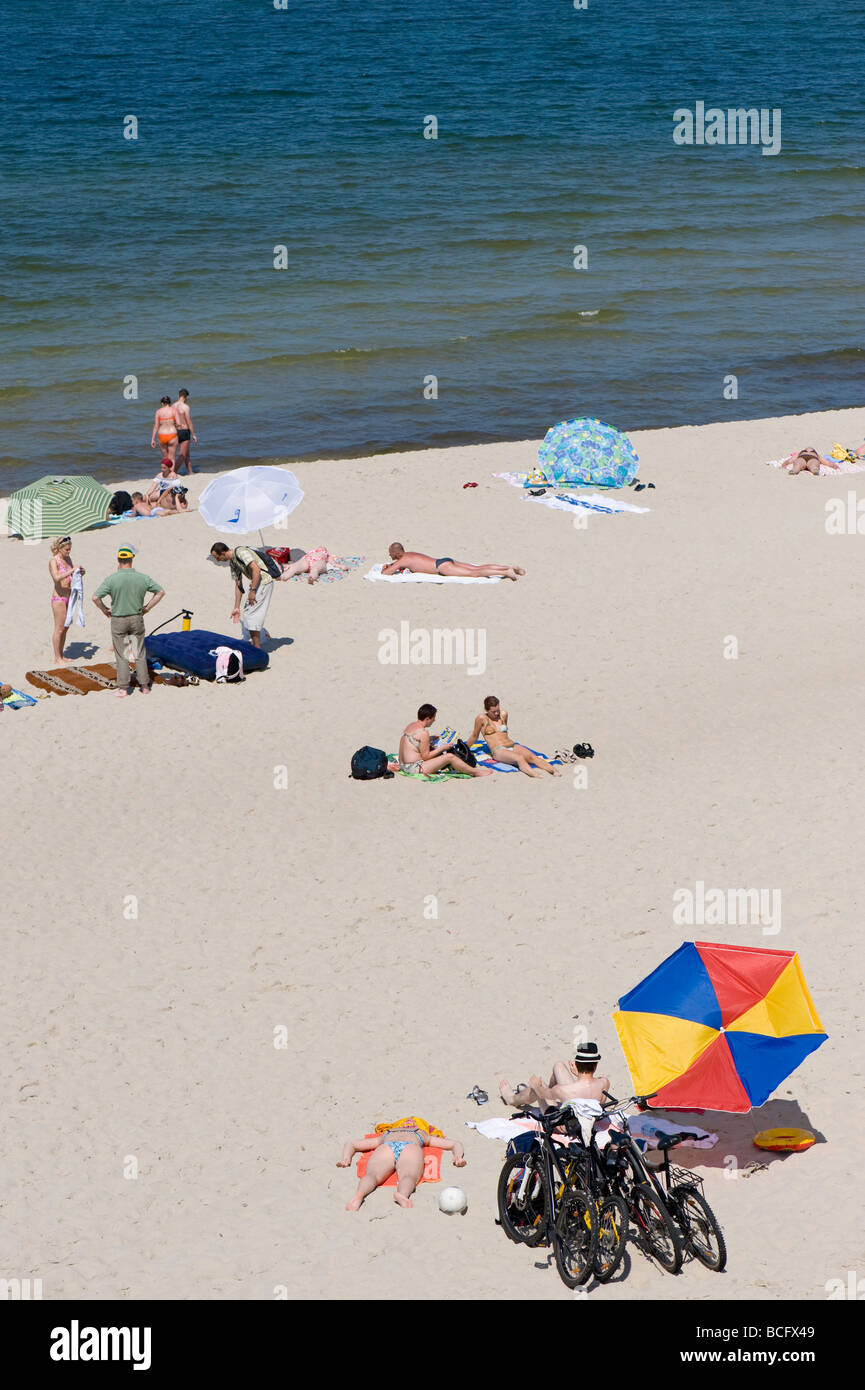People enjoy hot summer day on sandy beach Baltic Sea Nida village ...