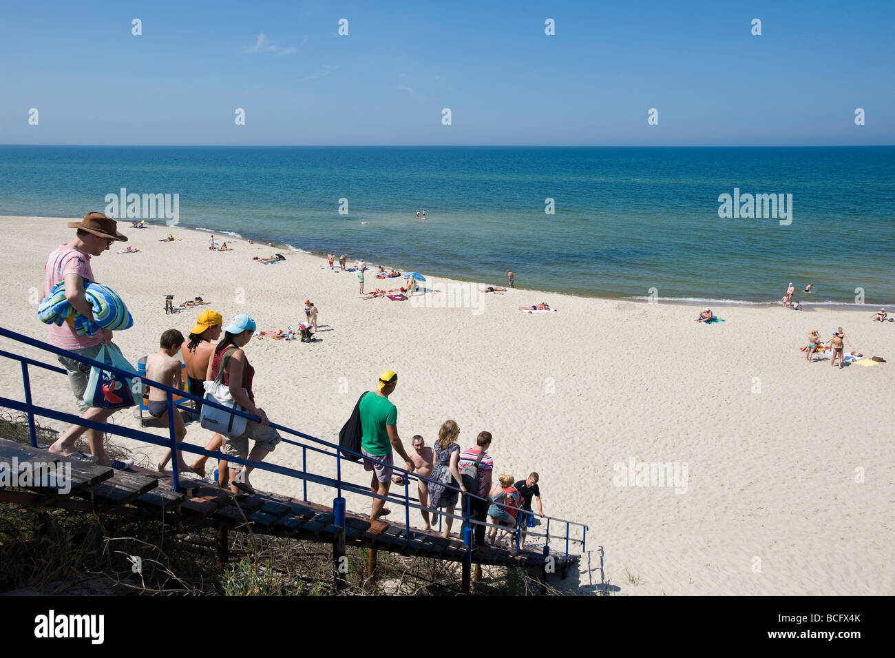 People enjoy hot summer day on sandy beach Baltic Sea Nida village ...