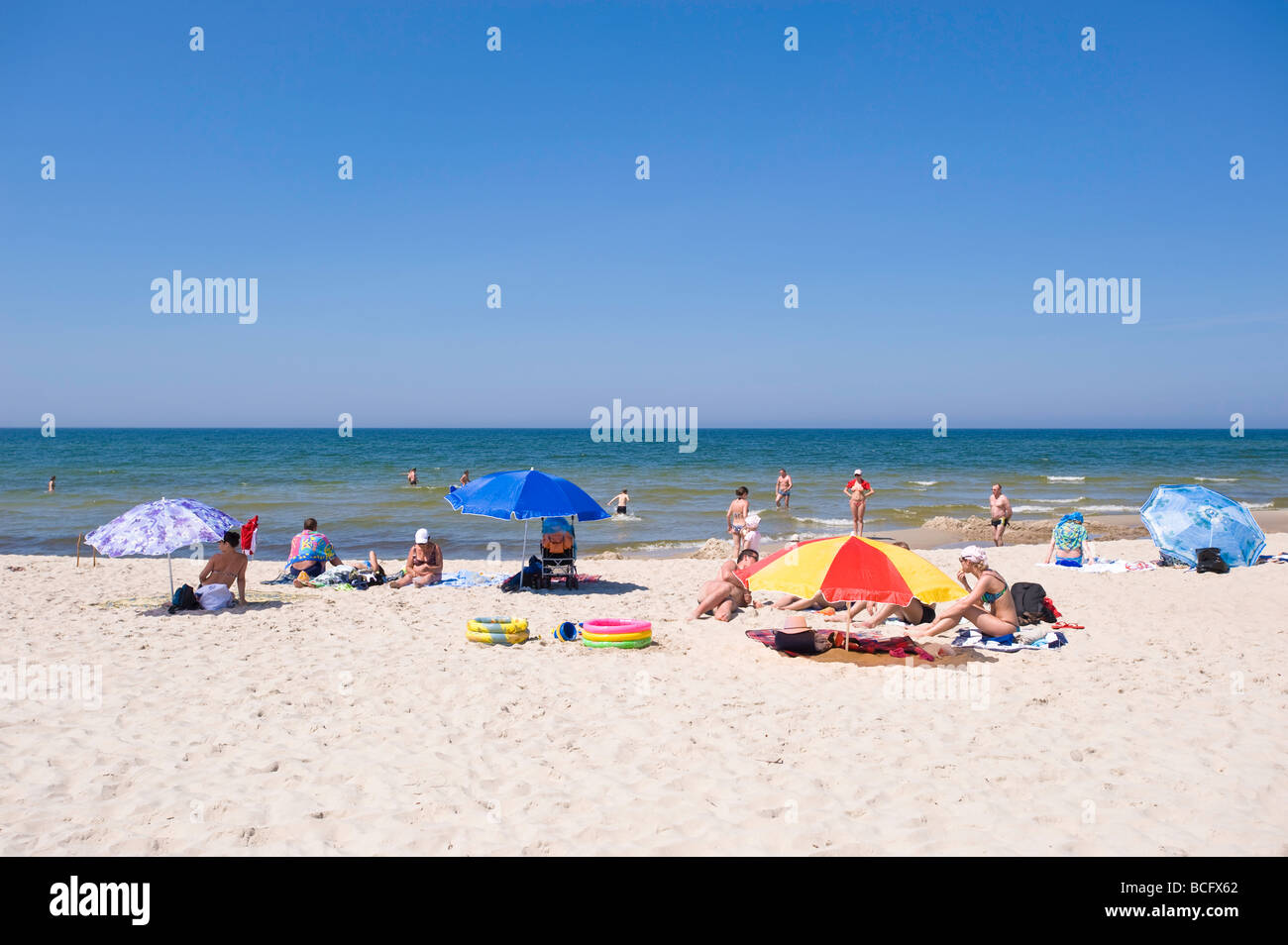 People enjoy hot summer day on sandy beach Baltic Sea Nida village ...