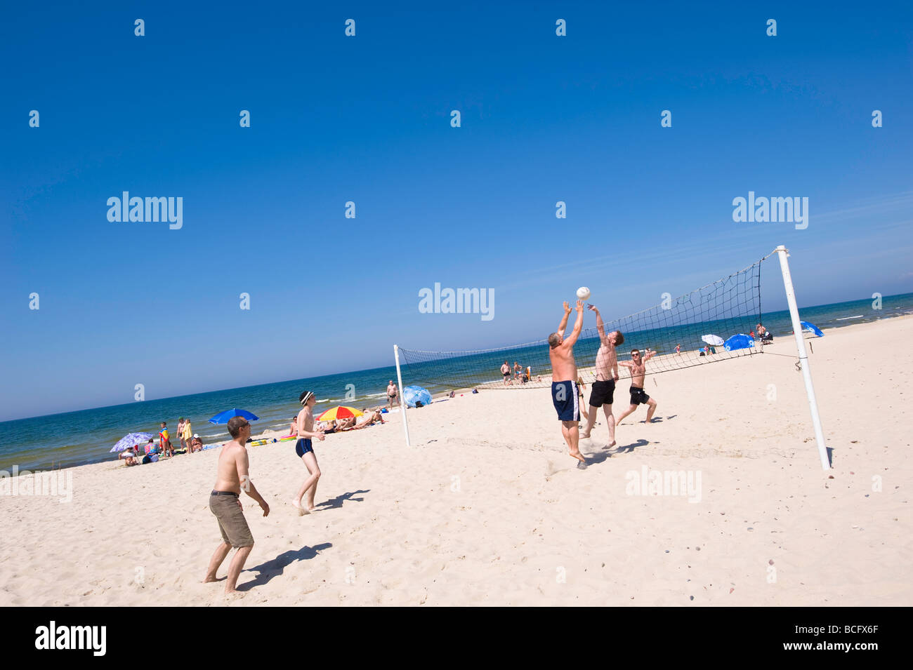 People enjoy hot summer day on sandy beach Baltic Sea Nida village ...