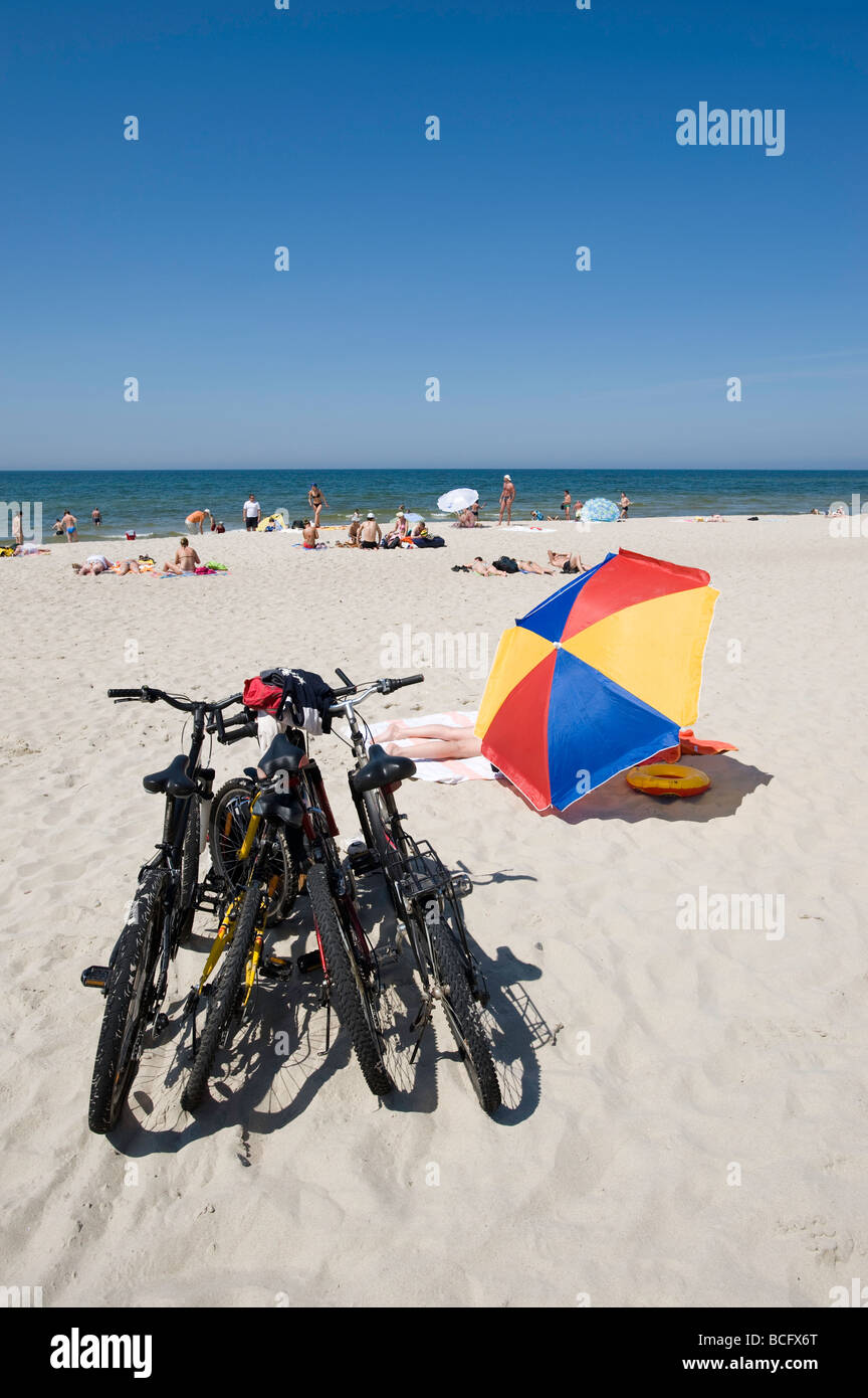 People enjoy hot summer day on sandy beach Baltic Sea Nida village ...