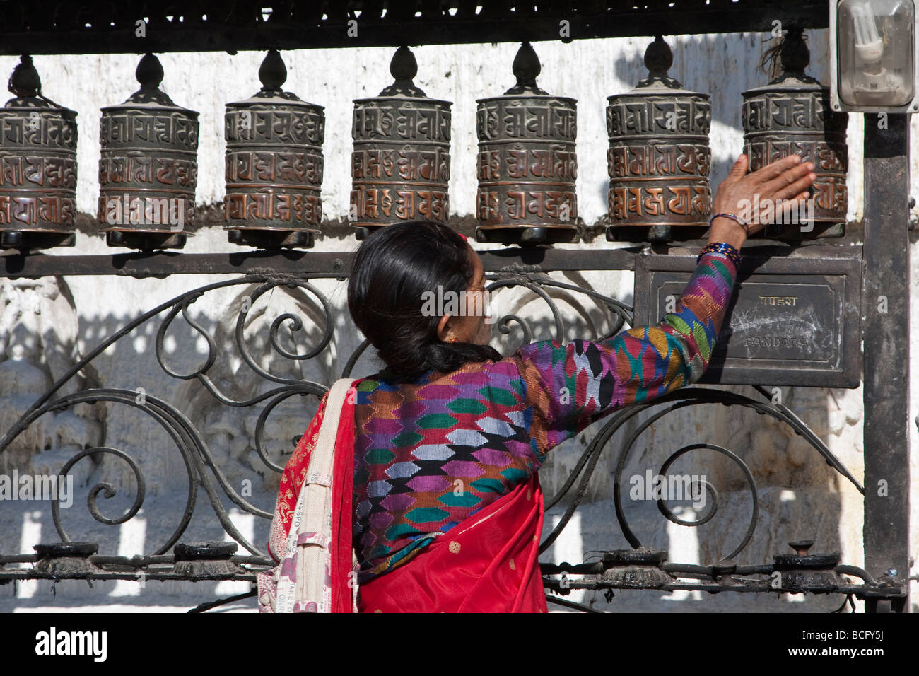 Woman turning prayer wheel hi-res stock photography and images - Alamy