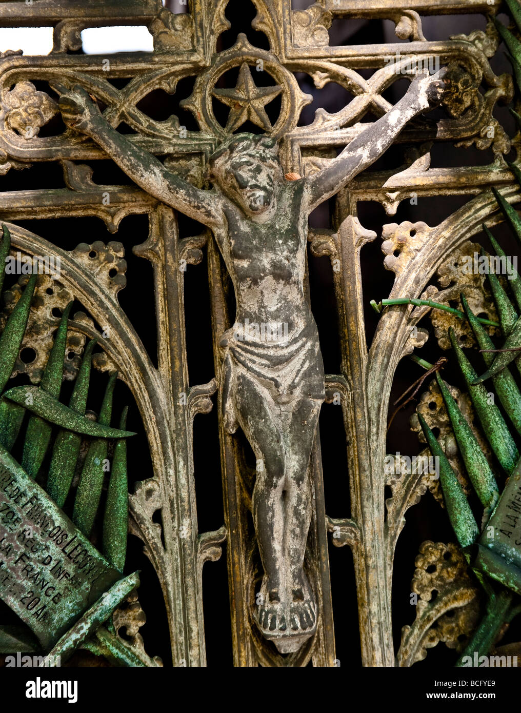 The weathered figure of Jesus on the gate of a family tomb Stock Photo ...