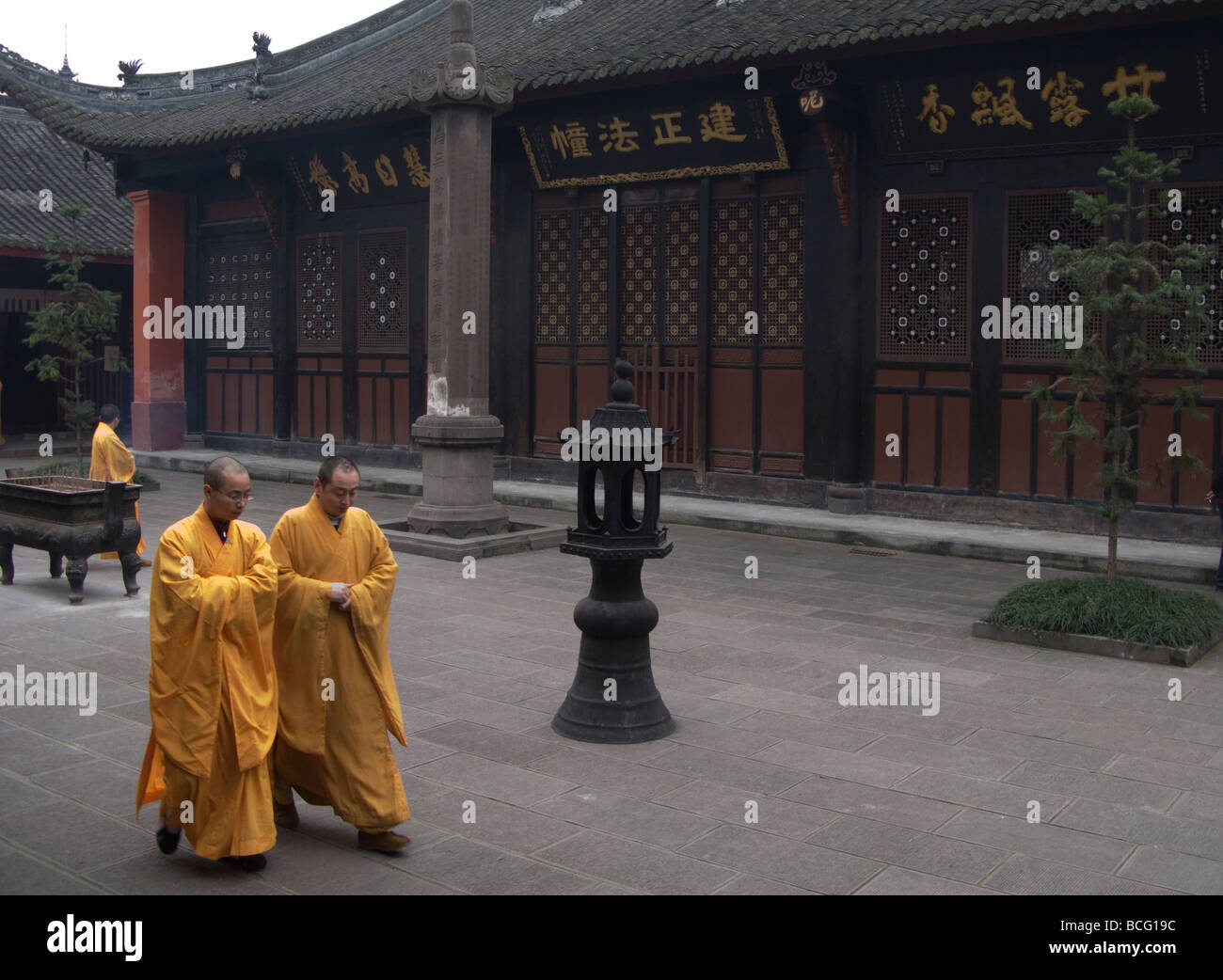monks walk by the Tang Dynasty Buddhist Wenshu Monastery , the largest ...