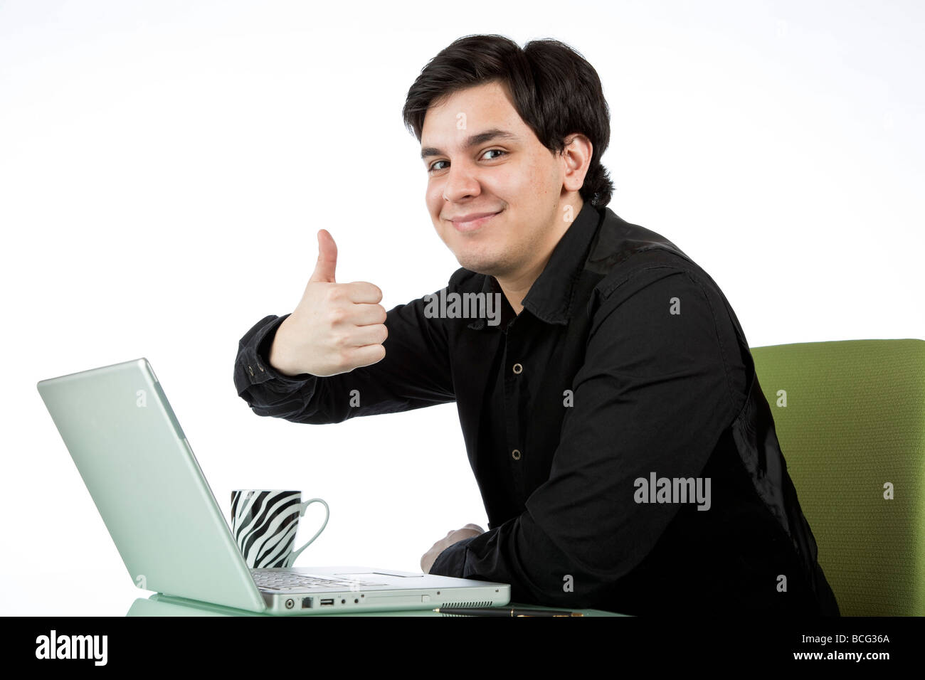 Latino man working at a laptop computer isolated on white Stock Photo ...