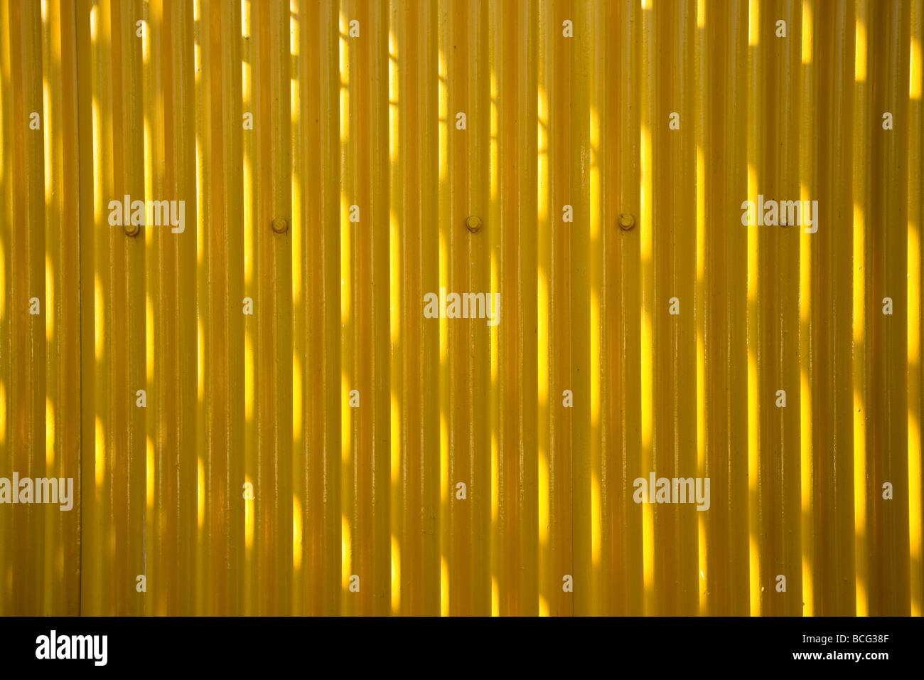Yellow steel wall with rays of sunlight Stock Photo - Alamy