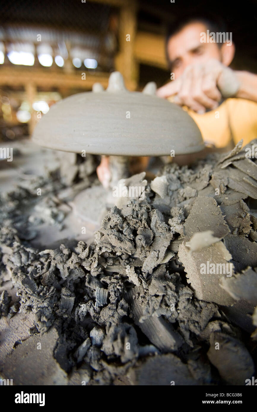 An artisan works on finishing details in Guaitil Costa Rica. Guaitil is ...