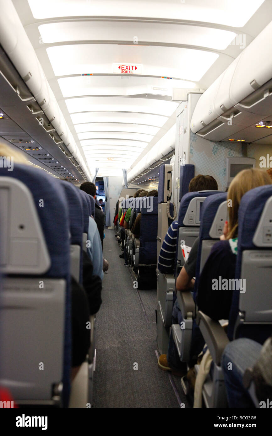 Airplane aisle with passengers Stock Photo - Alamy